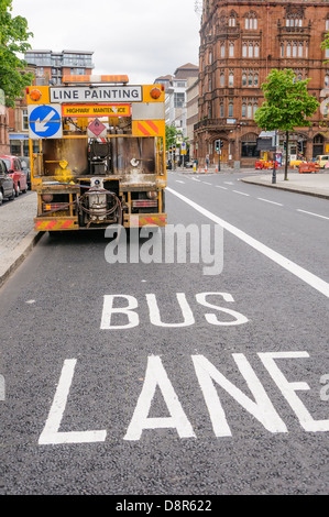 Line Painting lorry on a newly painted bus lane Stock Photo - Alamy