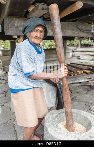 Woman pounding rice in a rural village, Batad, Luzon, Philippines Stock ...