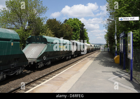 A freight train passing through Edale railway station platform in the ...