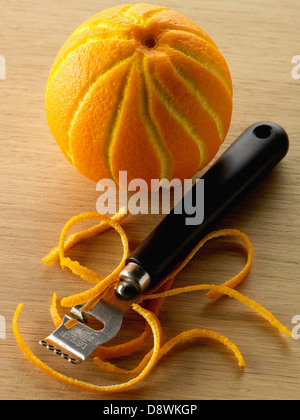 Making orange zests with a zester Stock Photo - Alamy