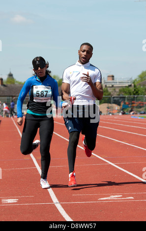 Blind runner with guide runner, running in the TCS London Marathon 2022 ...