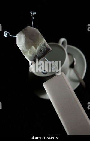 Tea bag diving into a cup Stock Photo - Alamy