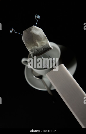 Tea bag diving into a cup Stock Photo - Alamy