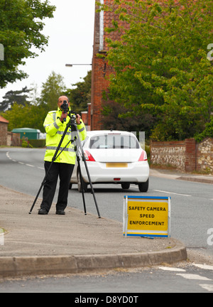 Man using speed camera to monitor traffic speeds Stock Photo - Alamy