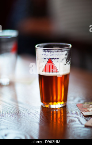 Half full pint glass of beer lager Stock Photo - Alamy