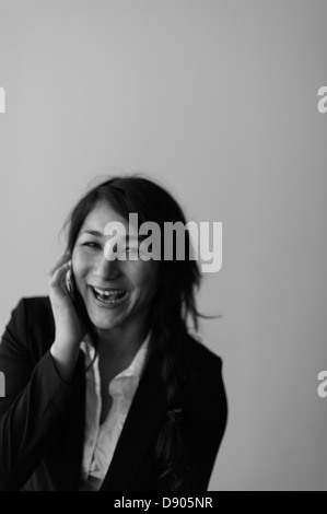 Young white woman using smartphone while sitting at table in room Stock ...