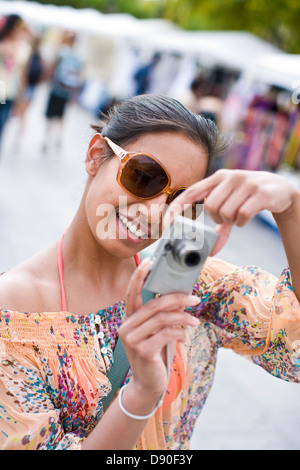 Brunette woman using digital camera Stock Photo - Alamy