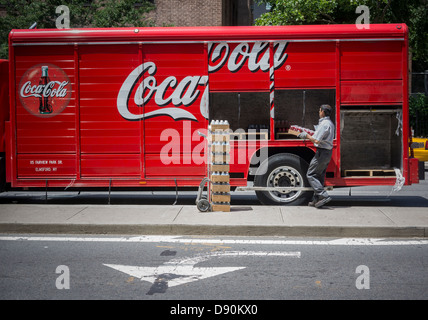 Delivery man brings a supply of Coca Cola and Pepsi Cola to a ...