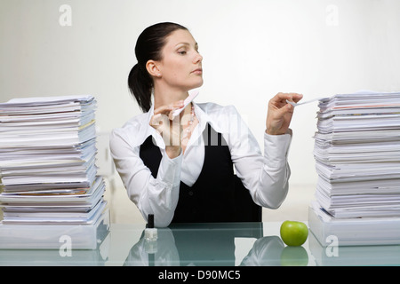 A woman doing her nails in an office, Sqweden Stock Photo - Alamy