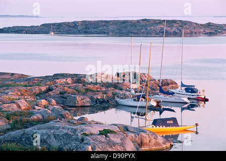 rocks blue sea, boats on the water travel and leisure Stock Photo - Alamy
