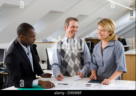 Coworkers having a business discussion in office, light effect Stock ...
