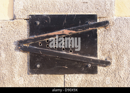 Metal sheet bolted on wall, close-up Stock Photo - Alamy