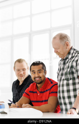 Three students in the library Stock Photo - Alamy