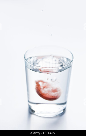 Pill melting in glass of water Stock Photo - Alamy