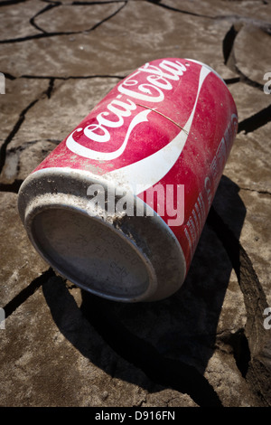 Cracked dry earth with coca cola can Stock Photo - Alamy