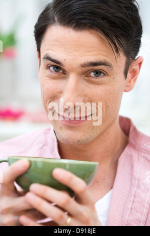 A man holding a a cup of tea, Sweden Stock Photo - Alamy