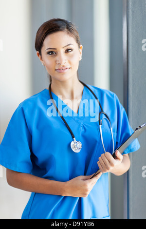 portrait of cheerful woman holding clipboard in hands in office Stock ...