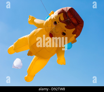 Vibrant, colourful kite flying in a blue sky with white clouds Stock ...
