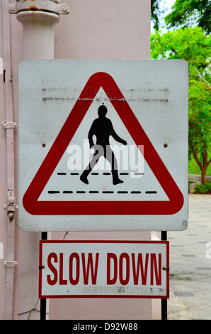 slow down red triangle road sign traffic calming measures blue sky ...