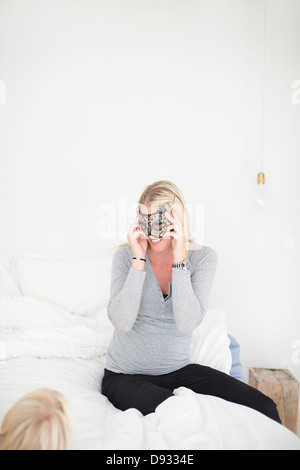 A happy family mother and child pack Christmas gifts. Lifestyle. New ...