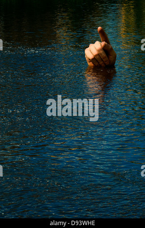 human hand of the person about to drown in the middle of the sea after ...