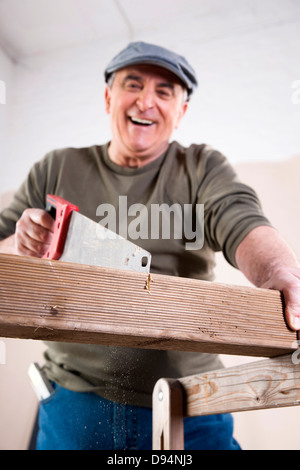 low angle view of woodworker cutting board with miter saw Stock Photo ...