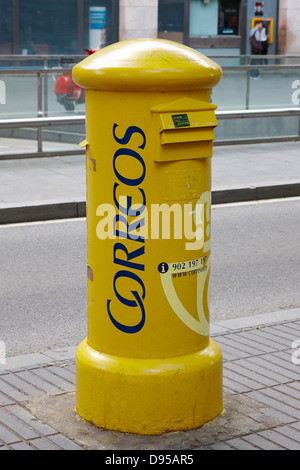 Yellow Spanish post box of the national postal service, Correos, in ...