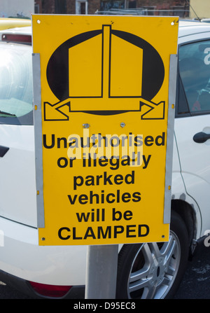 A wheel clamping warning sign in a private car park in a U.K. city ...
