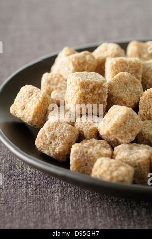 Brown colored,sugar cubes on kraft paper with grain of sugar and copy ...
