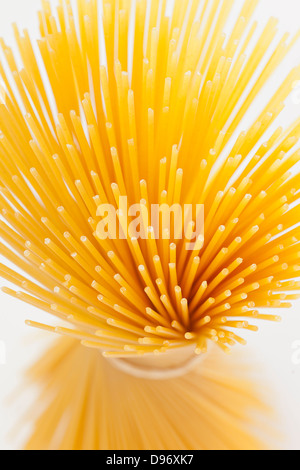 A Bundle of dry spaghetti ready to cook Stock Photo - Alamy