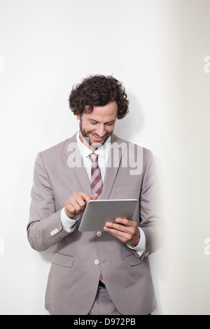 Germany, Cologne, businessman using digital tablet on bench Stock Photo ...