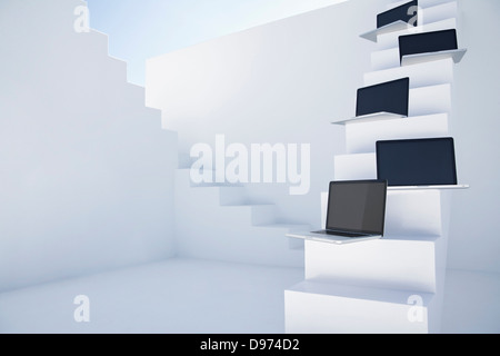 Laptops on white modern stairs Stock Photo - Alamy