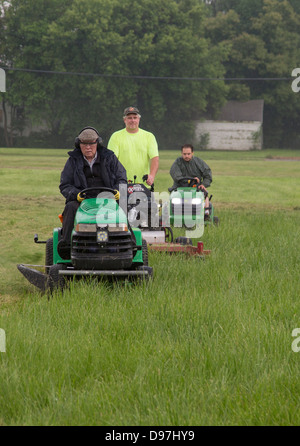 The Detroit Mower Gang, an informal group of volunteers, cuts the grass ...