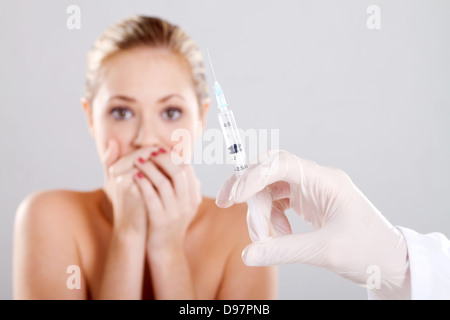 Portrait of a scary beautiful woman, with a needle injection treatment ...