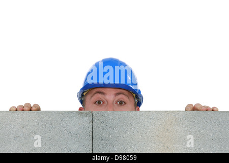 Construction worker hiding behind a wall Stock Photo - Alamy