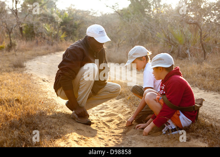 Robin Tetlow Shooter & Tyler Talmage studying game tracks on the sand ...