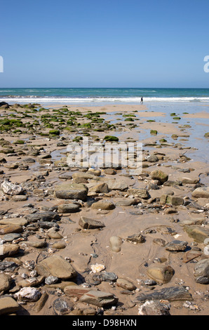 Sunny beach with large rocks in the sea and clear blue sky, peaceful ...