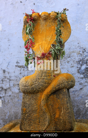 Naga. Indian cobra deity stone idols covered in flower garlands for ...