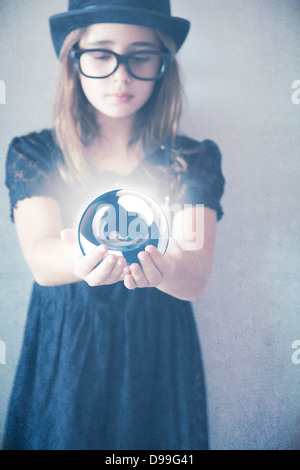 Pretty girl holding a magic ball Stock Photo - Alamy