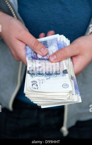 person holding three thousand pounds cash fanned Stock Photo - Alamy