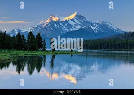 Mt Charlton and Mt Unwin reflected in Maligne Lake at dawn Jasper ...