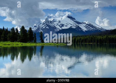 Mt Charlton and Mt Unwin reflected in Maligne Lake at dawn Jasper ...