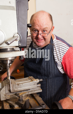 Factory worker operating drill press in magnet factory, Gauteng, South ...
