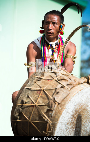 Tribal man playing traditional musical instrument Dholak or drums ...