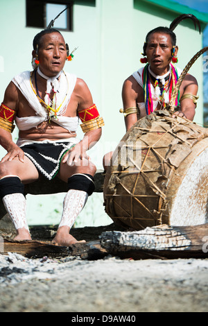 Naga tribal men playing musical instrument, Hornbill Festival, Kohima ...