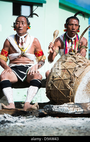 Naga tribal men playing musical instrument, Hornbill Festival, Kohima ...