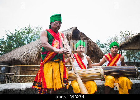 Tribal men playing musical instruments during Karma Puja festival ...