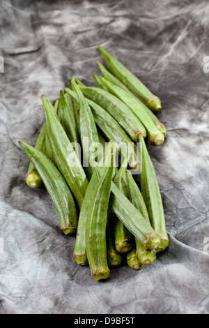 Okra beans on textile, close up Stock Photo - Alamy