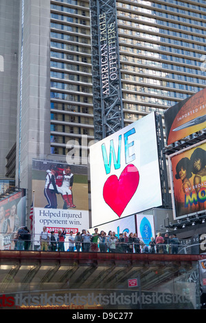 Times Square in the heart of New York City with glowing signs, tourist ...