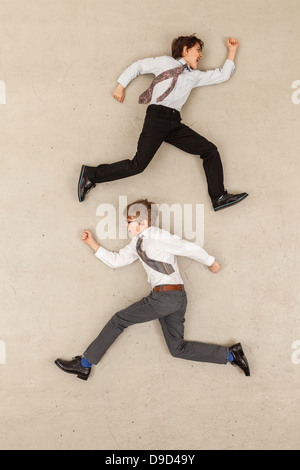 Business people running in opposite direction Stock Photo - Alamy